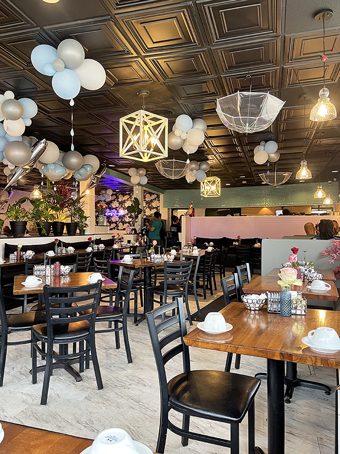 Whimsical umbrellas and balloon clusters float above diners, creating an atmosphere that's part celebration, part culinary dreamscape.