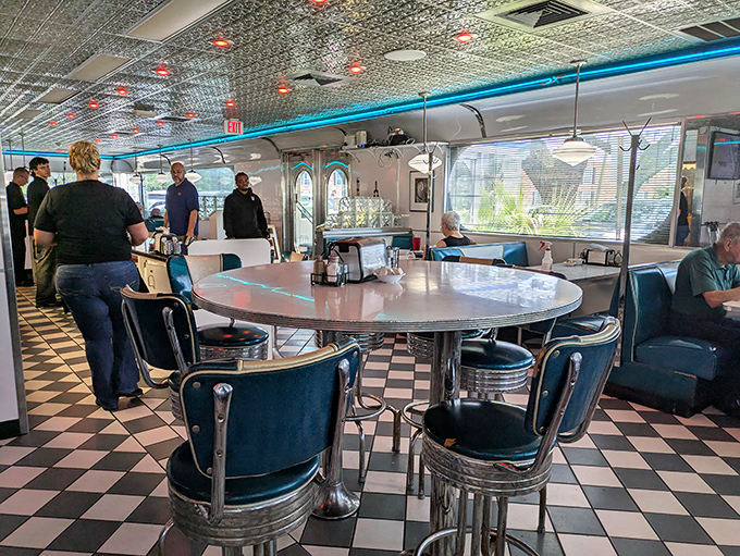 The quintessential diner interior&mdash;checkered floors, blue vinyl seats, and that counter where breakfast dreams come true. This isn't Instagram bait; it's the real deal.