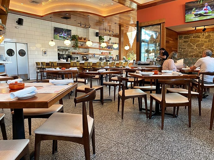 Inside, warm wood tones meet sleek design elements, creating a space where farmhouse charm and urban sophistication have a delightful first date.