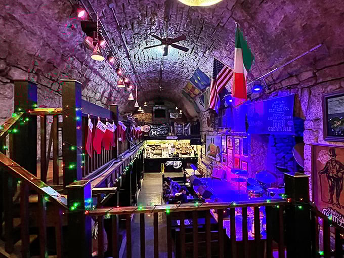 Descend into this limestone cathedral of merriment where Irish flags, twinkling lights, and centuries-old stone walls create an atmosphere that whiskey couldn't improve.