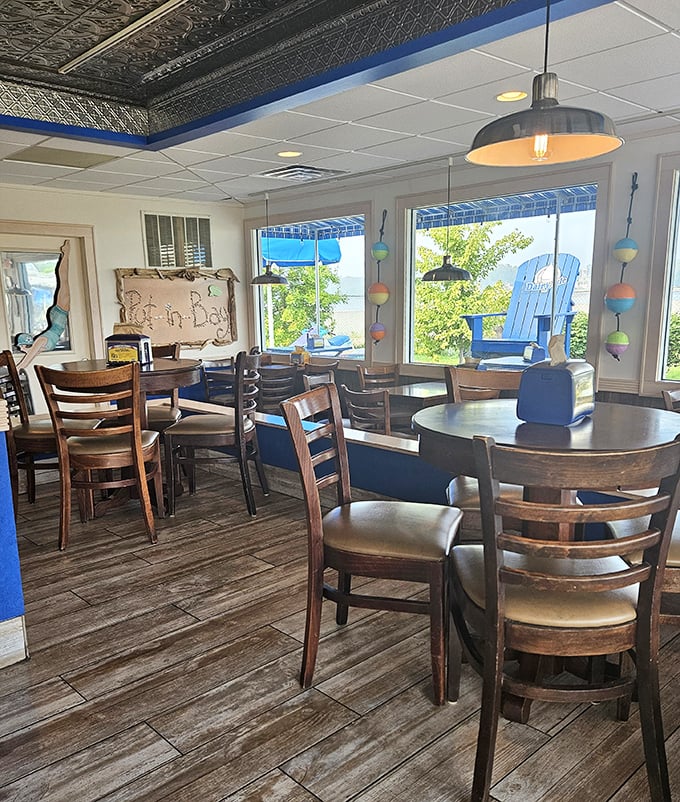 Inside, nautical charm meets island comfort&mdash;wooden tables, buoy decorations, and windows framing views that remind you: yes, you're on vacation now.