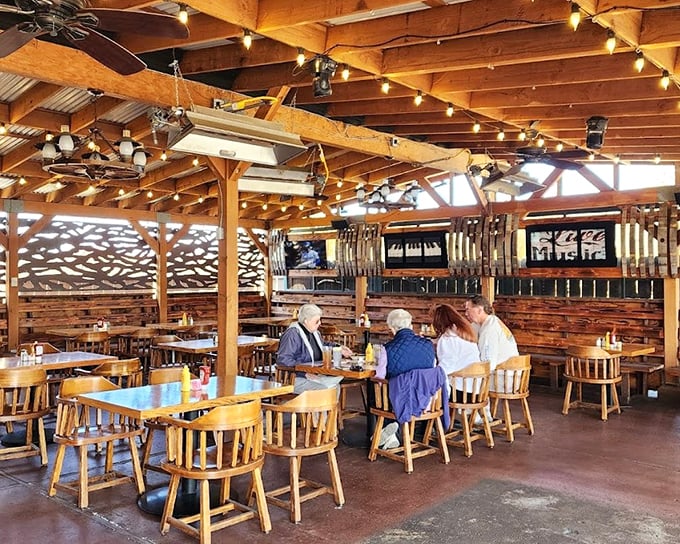 Exposed wooden beams, twinkling string lights, and warm wood paneling create the kind of cozy dining atmosphere where memories are made and prime rib dreams come true.