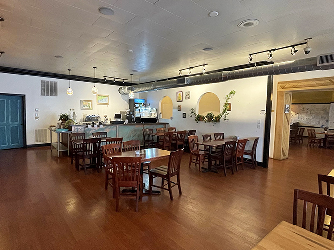 Warm wooden floors, comfortable seating, and exposed ductwork create that perfect balance of cozy-meets-contemporary that makes you want to linger over coffee.