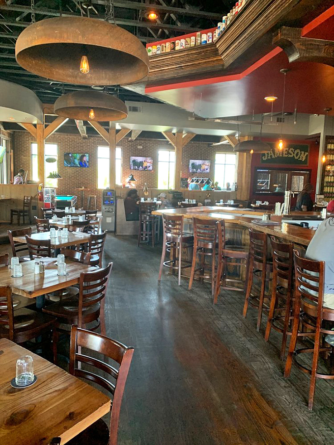 Industrial chic meets neighborhood comfort inside Corner Tavern, where oversized pendant lights cast a warm glow over wooden tables that have hosted countless happy conversations.