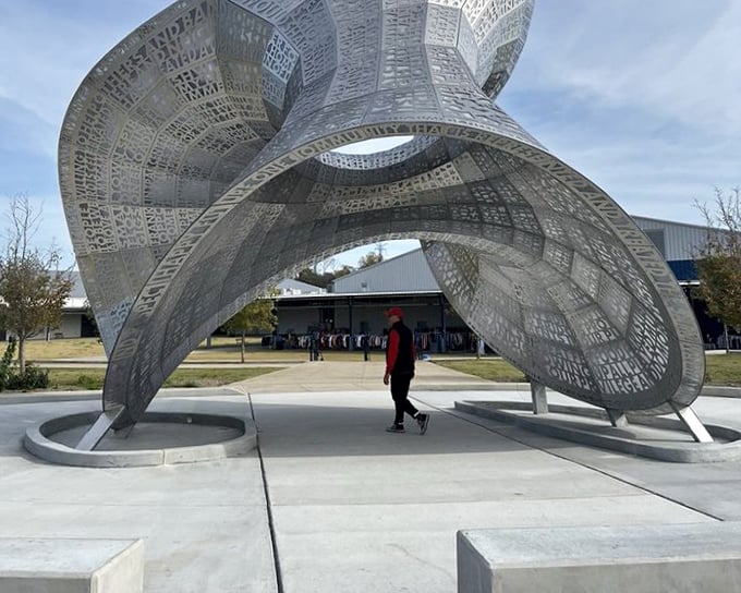 This stunning sculpture greets visitors like a metallic welcome mat, proving art appreciation starts before shopping.