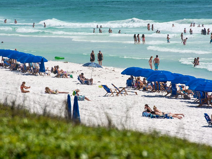 Beach therapy in session! Nothing says "I'm on vacation" like a sea of blue umbrellas against that impossible turquoise water.