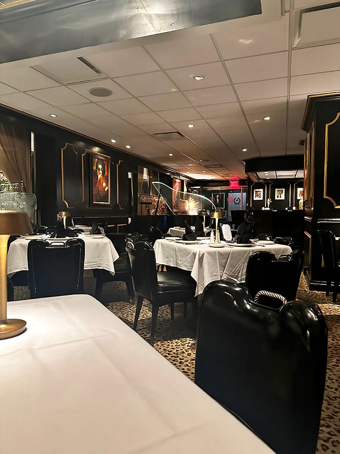 Black lacquered walls, leopard print carpet, and white tablecloths—this isn't just dinner, it's time travel to when Sinatra ruled and martinis were mandatory.