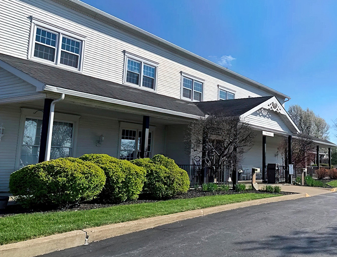 The Amish Door Restaurant's impressive white facade stands tall like a beacon of hope for hungry travelers seeking authentic country cooking.