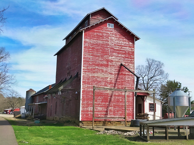 That red grain elevator stands like a gentle giant, reminding us when communities grew around honest work.