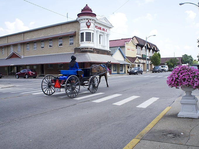 Downtown Berne's historic charm shines as a horse-drawn carriage passes the Pearl Oil building&mdash;Switzerland meets Indiana in perfect harmony.