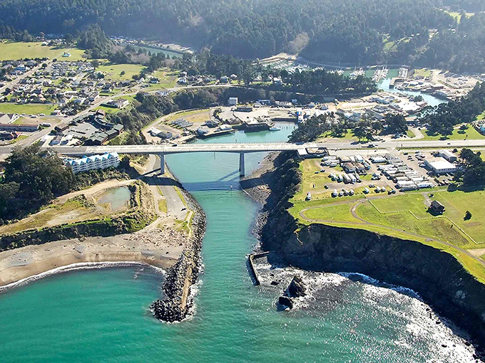 Fort Bragg's emerald waters stretch toward infinity, where small-town harbor life meets the wild Pacific's embrace. 