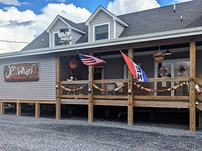 JP's wooden deck feels like coastal Delaware's front porch&mdash;flag fluttering, water views, and crab magic waiting inside.