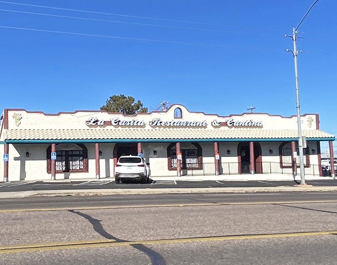 La Casita's unassuming storefront hides flavor bombs within. That blue trim and Spanish tile roof whisper "authentic" before you even step inside.