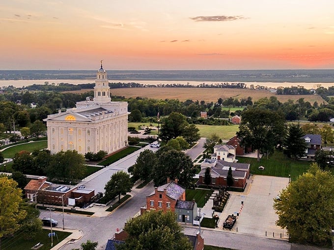 Nauvoo's gleaming temple commands the skyline at sunset, a beacon of history overlooking the mighty Mississippi.