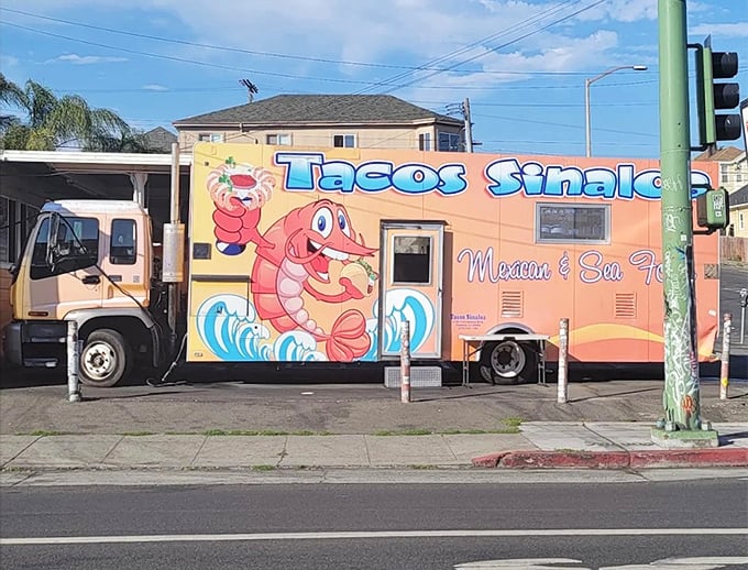 Tacos Sinaloa's cheerful shrimp mascot promises seafood delights from this vibrant orange food truck. Like finding a treasure chest of flavor on Oakland's streets!