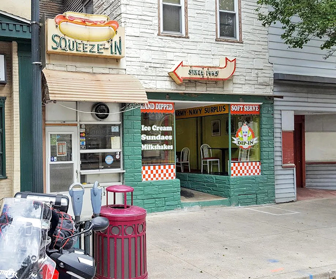 The Squeeze-In's turquoise facade and neon hot dog sign&mdash;like a 1950s postcard you can actually walk into.