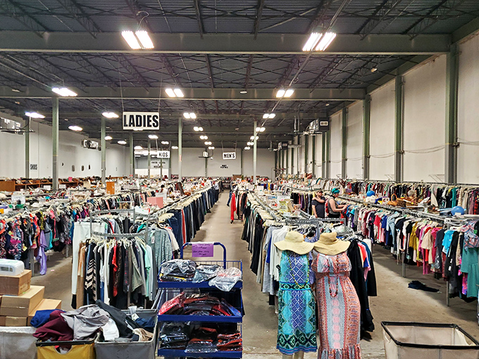 Rows upon rows of clothing stretch toward the horizon—a fabric forest where vintage gems hide among everyday threads.