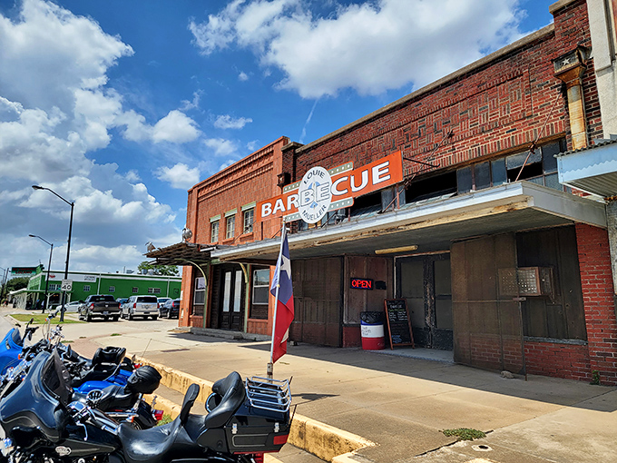 The Texas flag flies proudly outside Louie Mueller. Even the building looks seasoned with decades of perfect smoke.