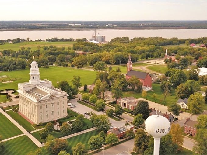 From this bird's-eye view, Nauvoo's historic charm spreads out beneath the water tower, the river a silver ribbon beyond.