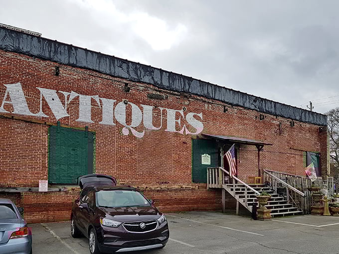 Payne Mill's weathered brick exterior tells stories before you even step inside. A temple of treasures behind that American flag.