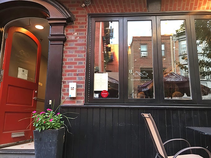 Red door, brick facade, seafood paradise. Seafood Unlimited's entrance is like the wardrobe to Narnia, but with crab cakes instead of lions.