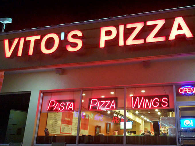 Vito's neon sign glows with late-night pizza possibilities. When that "OPEN" sign is lit, your midnight cravings have found their match.