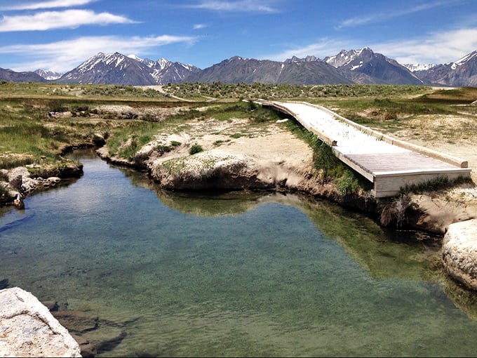 Snow-capped peaks frame this intimate mountain spring where silence becomes your best conversation partner.