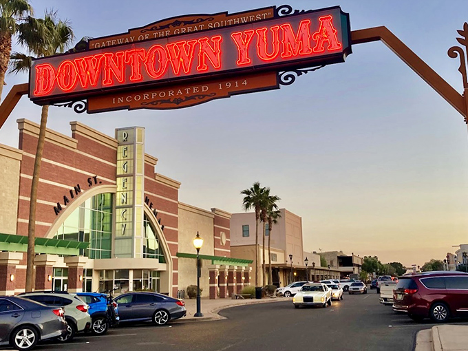 Yuma lights up at dusk, the neon glow announcing 'Downtown' like a beacon calling weary travelers to rest their bones and fill their bellies.