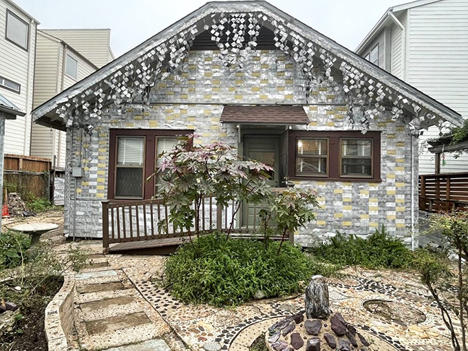 The back entrance reveals meticulous craftsmanship, with thousands of flattened cans creating a silver tapestry against Houston's urban landscape.