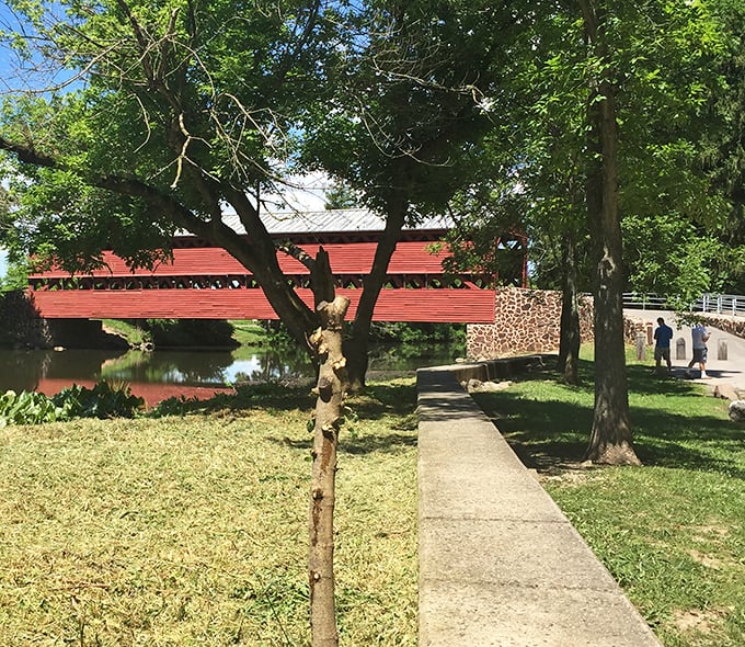 A peaceful walkway invites visitors to approach the bridge slowly, savoring each step toward this historical treasure.