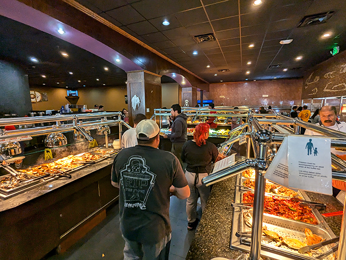 The buffet line stretches like a United Nations of comfort food, where steam table diplomacy brings together dishes from across continents under one roof.