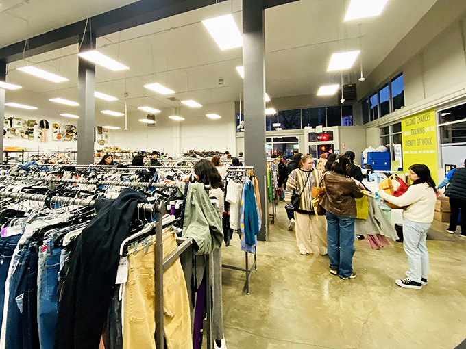 The real magic of thrifting happens in these aisles, where strangers united by the thrill of the hunt scan racks for that perfect unexpected find.