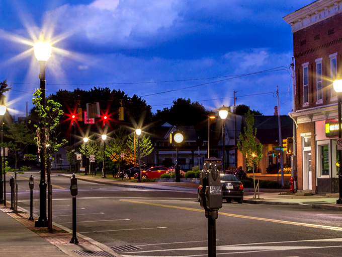 As twilight falls, Milton's vintage lampposts cast a warm glow on streets that feel like a time capsule&mdash;minus the dial-up internet and shoulder pads.