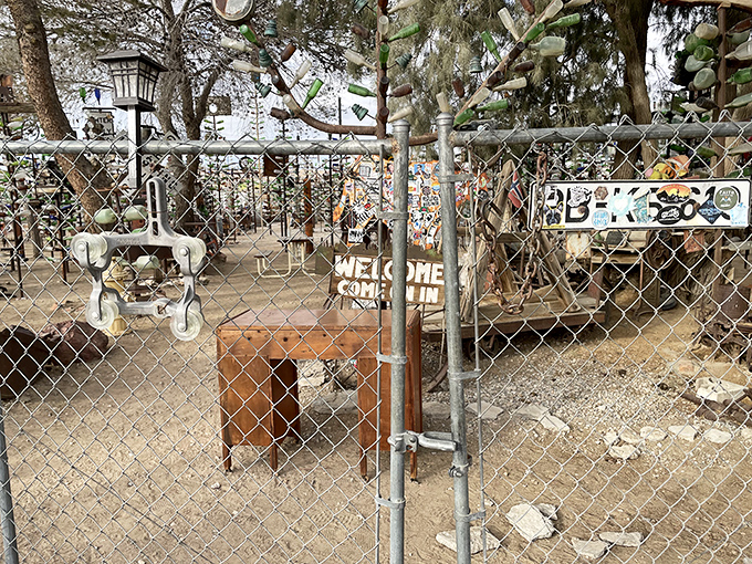 Welcome never looked so wonderfully weird. The entrance beckons with promises of bottle-based brilliance just beyond the chain-link.