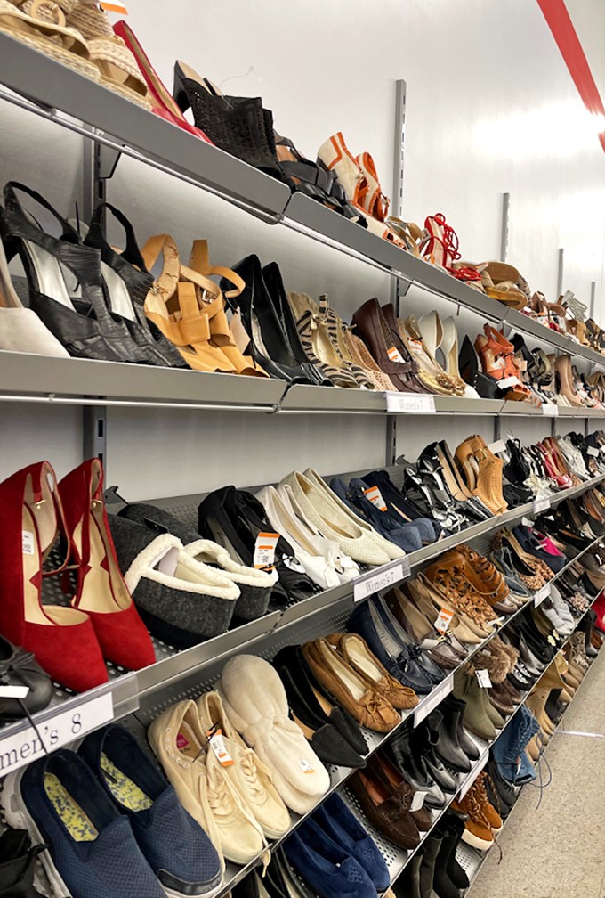 A shoe lover's dream realized in multiple shelves of footwear possibilities. From red power pumps to sensible flats, each pair awaits its Cinderella moment.