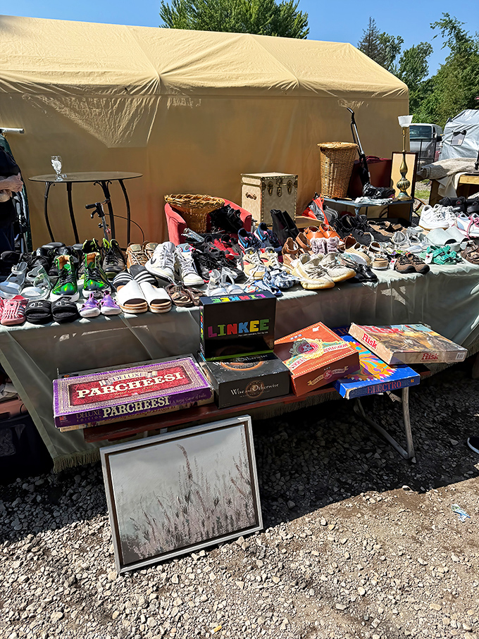 Vintage board games and barely-worn footwear share table space in perfect harmony. Parcheesi and sneakers: the unexpected power couple of flea markets.