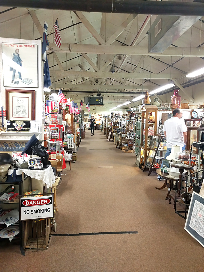 Wide, welcoming aisles invite exploration between vendor booths, with patriotic flair and exposed beams adding character to this treasure-seeker's paradise.