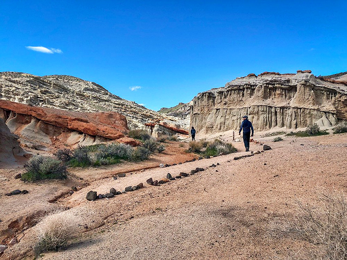 Following the path less traveled. Two hikers discover what early explorers knew—the best views always require a bit of desert dust on your boots.
