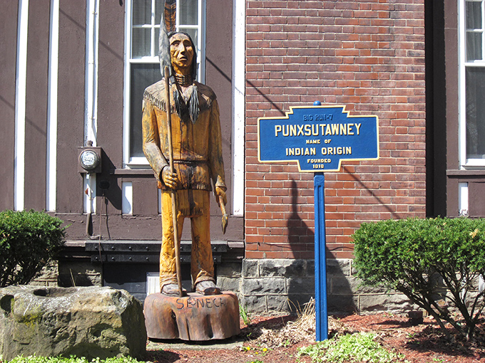 This wooden carving honors Punxsutawney's Native American heritage, with a historical marker explaining the town's name—which thankfully isn't on any spelling bee lists.