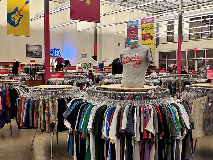 Fashion democracy in action! Circular racks create a colorful labyrinth where vintage tees and designer labels peacefully coexist.