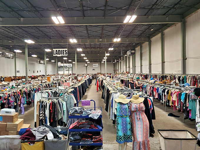 Rows upon rows of clothing stretch toward the horizon – a textile landscape where fashion time-travel happens for pennies on the dollar.