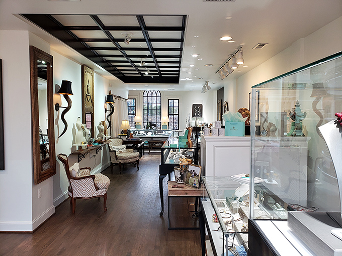 Elegance meets exploration in this bright, airy showroom where crystal display cases house miniature treasures while larger statement pieces command the floor.