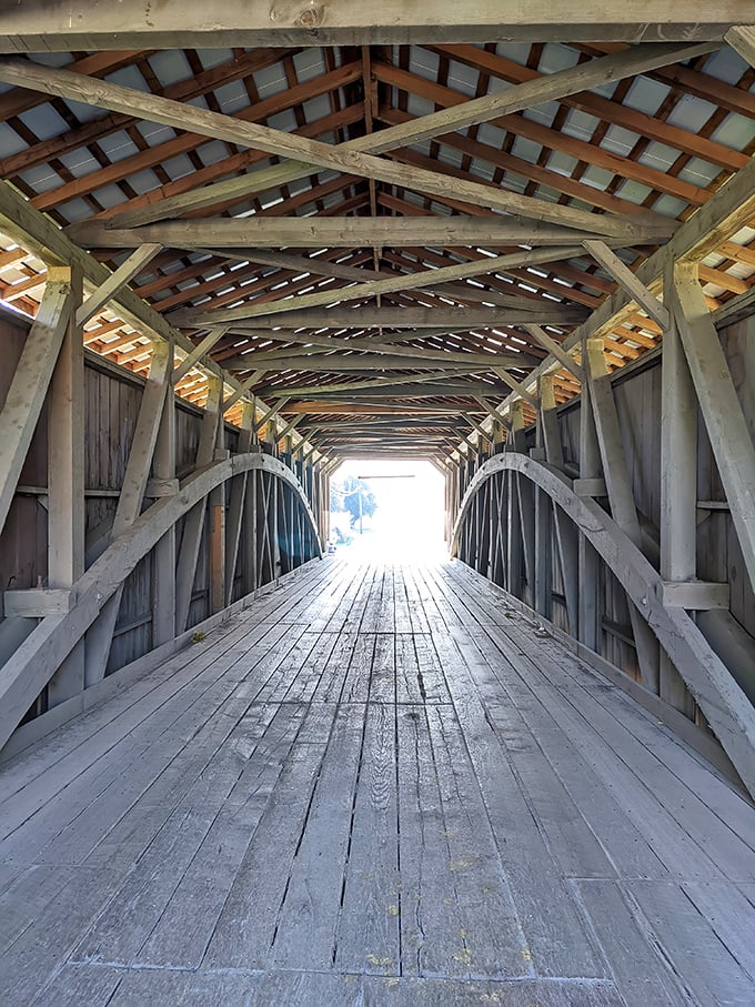 Looking down the wooden spine of history. These hand-hewn beams have witnessed generations of travelers, creating a cathedral-like passage over Pequea Creek.