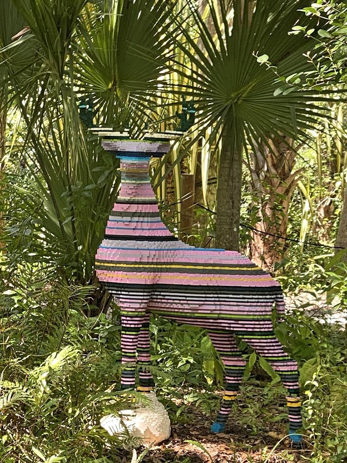 This colorful striped animal sculpture proves that even in a garden, art finds a way to make itself at home among the greenery.