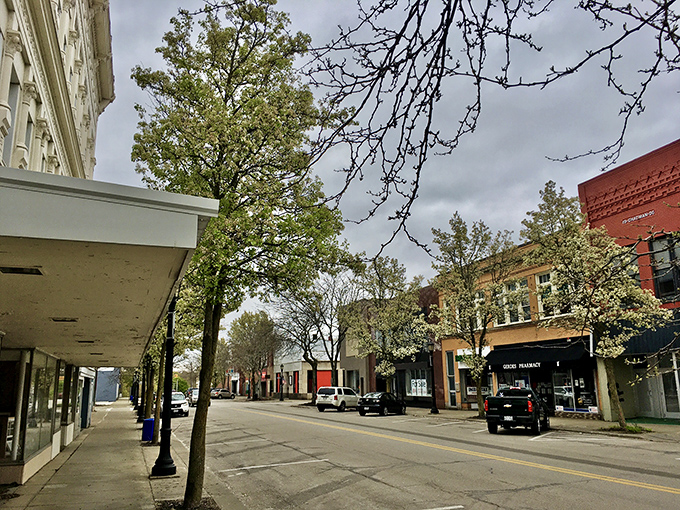 Spring blossoms dot Main Street with natural confetti, creating that perfect small-town tableau Norman Rockwell would have rushed to paint.