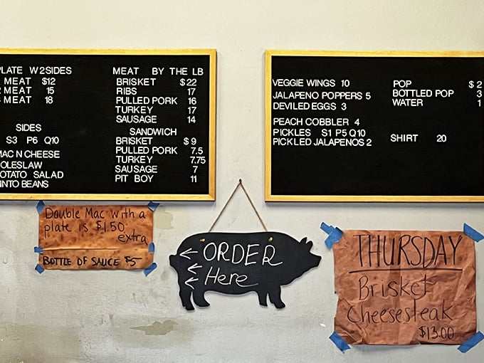 The chalkboard menu speaks the universal language of barbecue devotion. That "ORDER HERE" pig silhouette knows exactly what you're thinking.