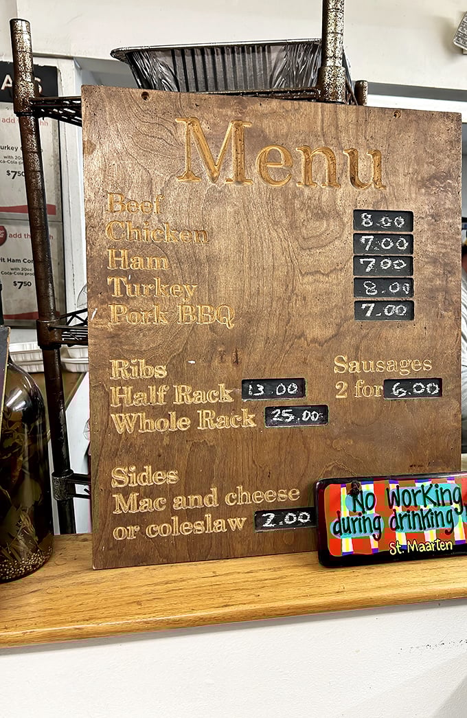 A menu carved in wood that tells you everything you need to know: meat options, sides, and the promise of ribs worth driving across state lines for.