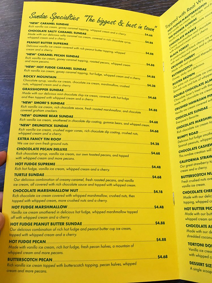 The golden-hued menu reads like a dessert manifesto, each sundae description more tempting than the last. Decision paralysis has never been sweeter.