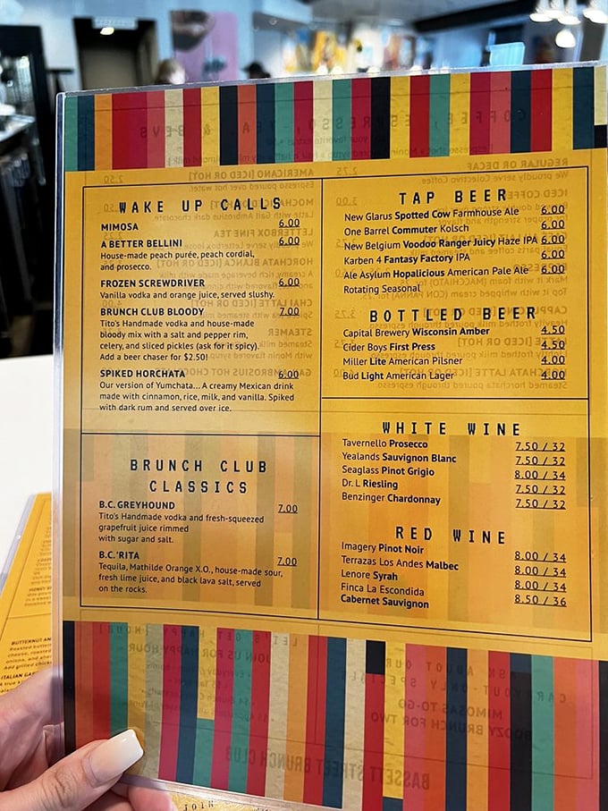 A menu that reads like a love letter to morning indulgence. The colorful border perfectly matches the vibrant personalities of their signature cocktails.