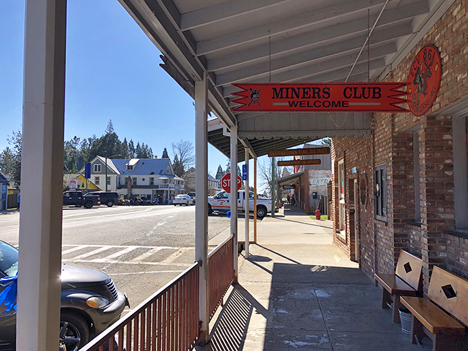The Miners Club welcomes visitors with a splash of red against brick walls, offering a glimpse into Georgetown's gold-digging past without the backbreaking labor.